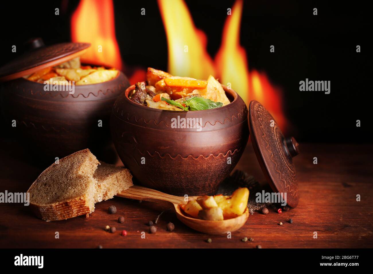 Homemade beef stir fry with vegetables in pots on wooden background ...