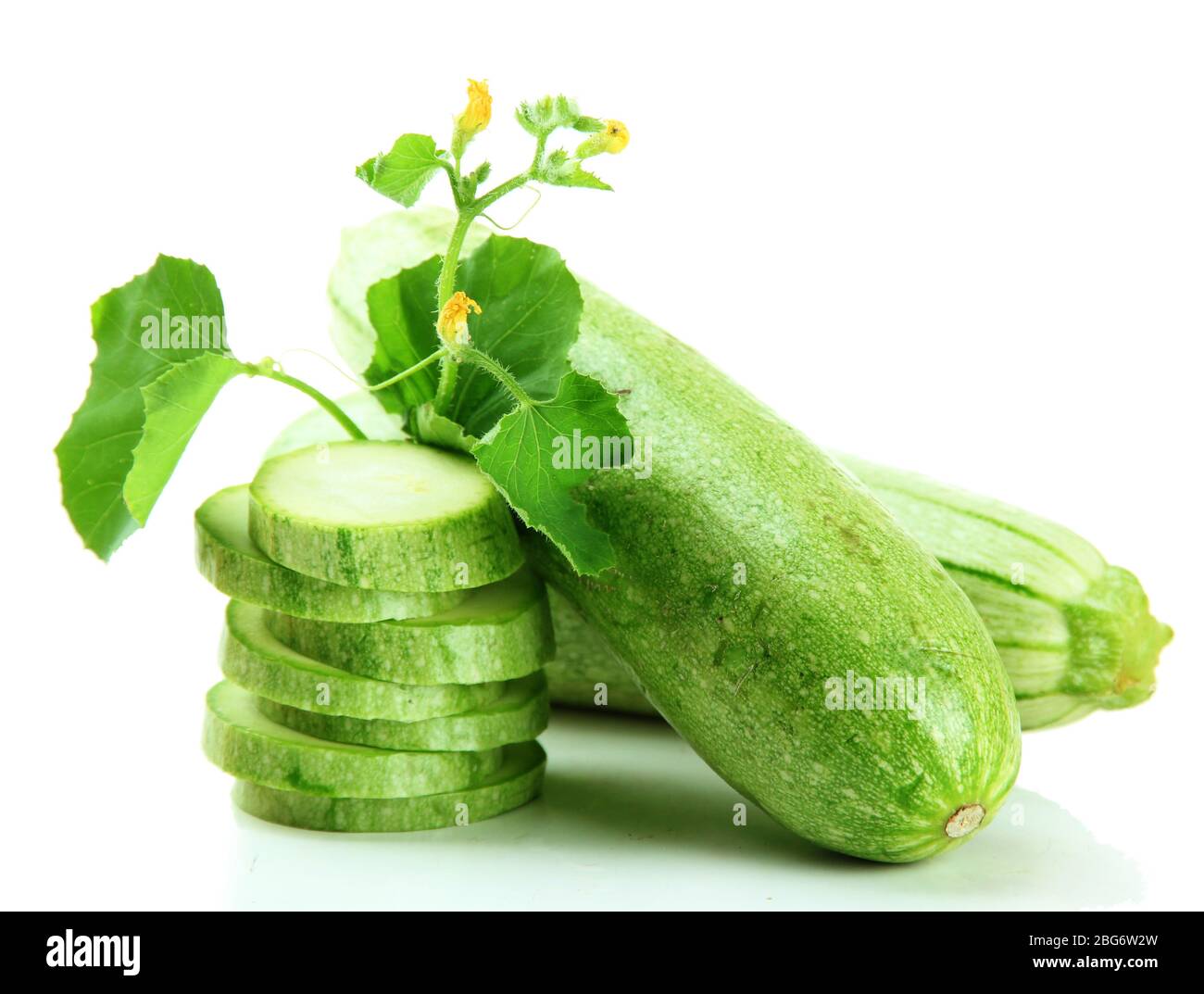Sliced and whole raw zucchini, isolated on white Stock Photo - Alamy