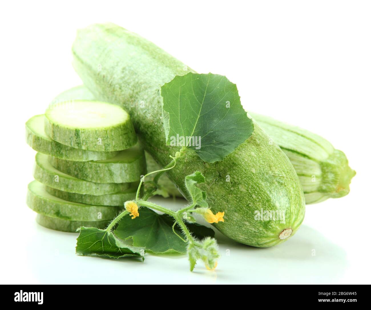 Sliced and whole raw zucchini, isolated on white Stock Photo - Alamy