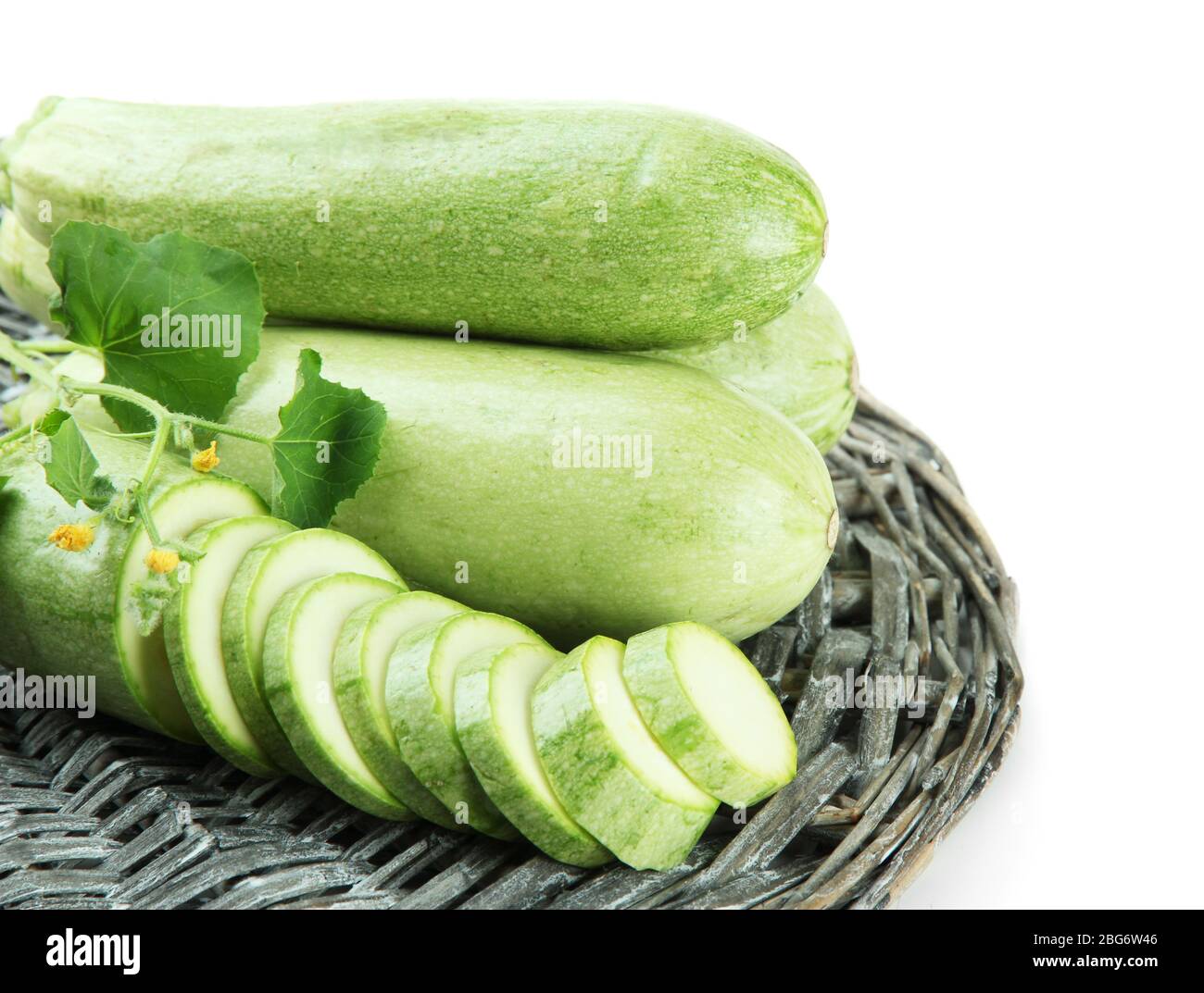 Sliced and whole raw zucchini, isolated on white Stock Photo - Alamy
