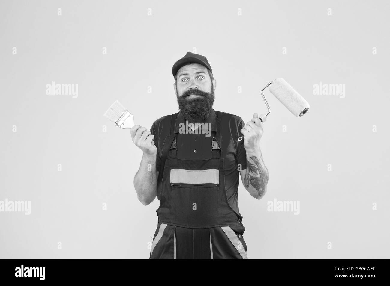 Man roller painting yellow Black and White Stock Photos & Images - Alamy