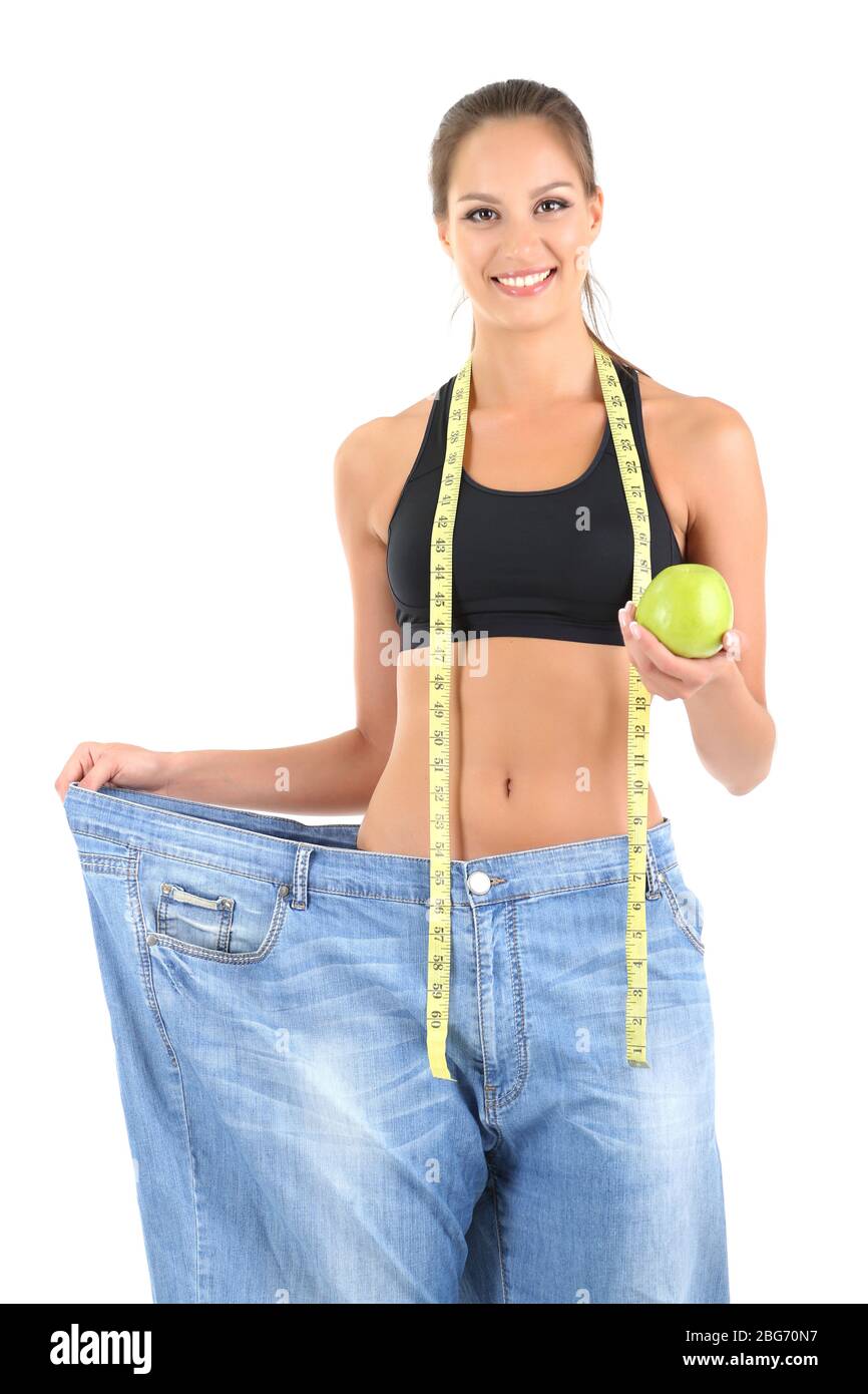 Slim girl in big jeans isolated on white Stock Photo - Alamy