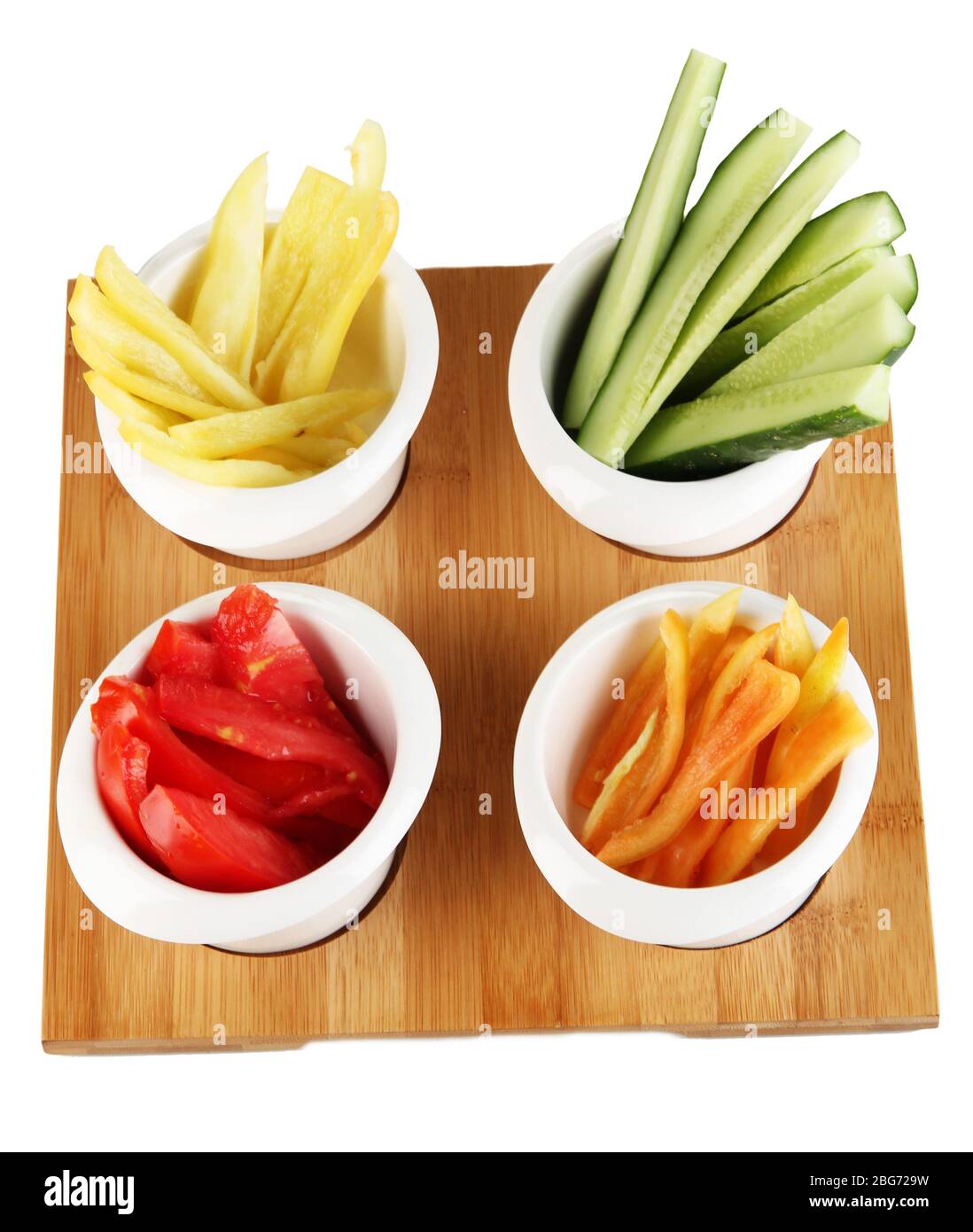 Bright fresh vegetables cut up slices in bowls isolated on white Stock ...