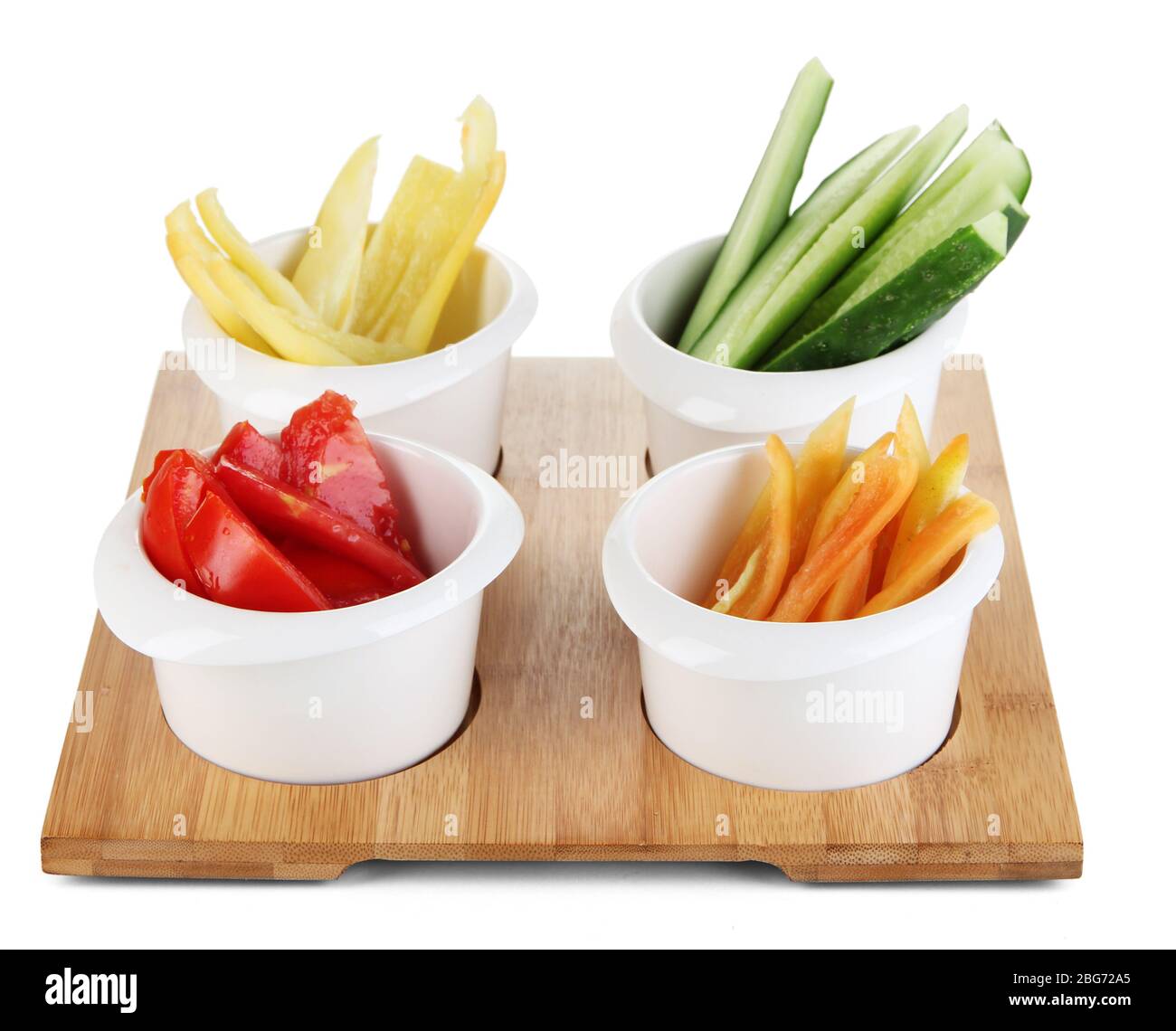 Bright fresh vegetables cut up slices in bowls isolated on white Stock ...
