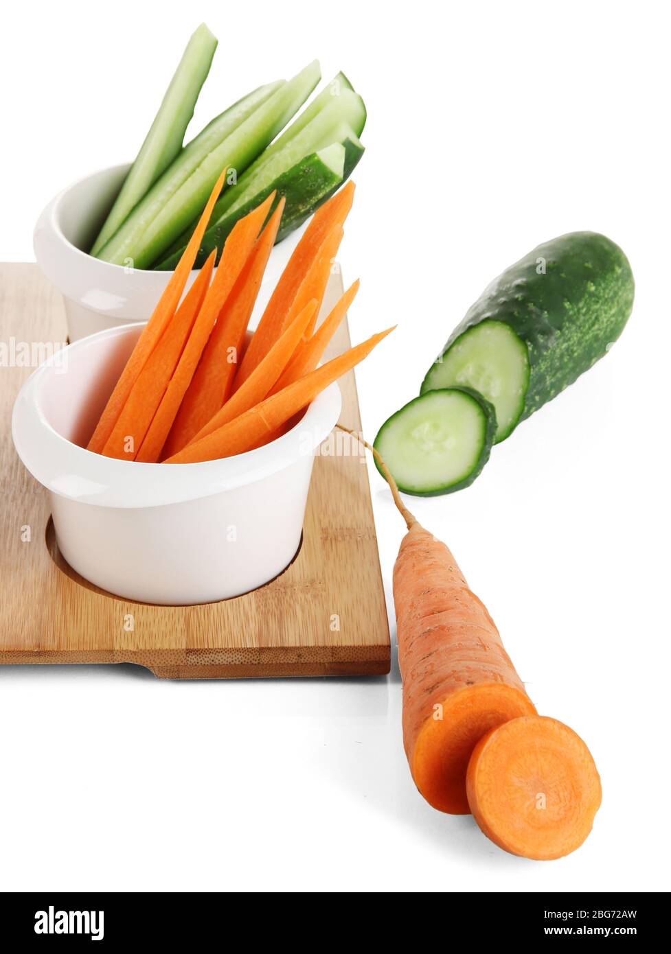 Bright fresh vegetables cut up slices in bowls isolated on white Stock ...
