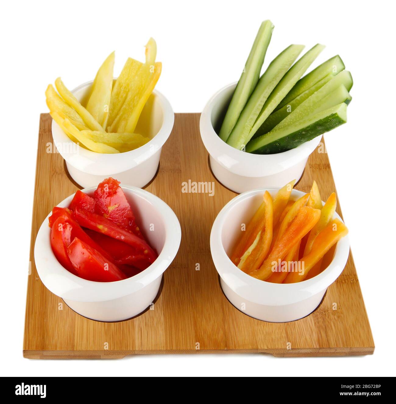 Bright fresh vegetables cut up slices in bowls isolated on white Stock ...