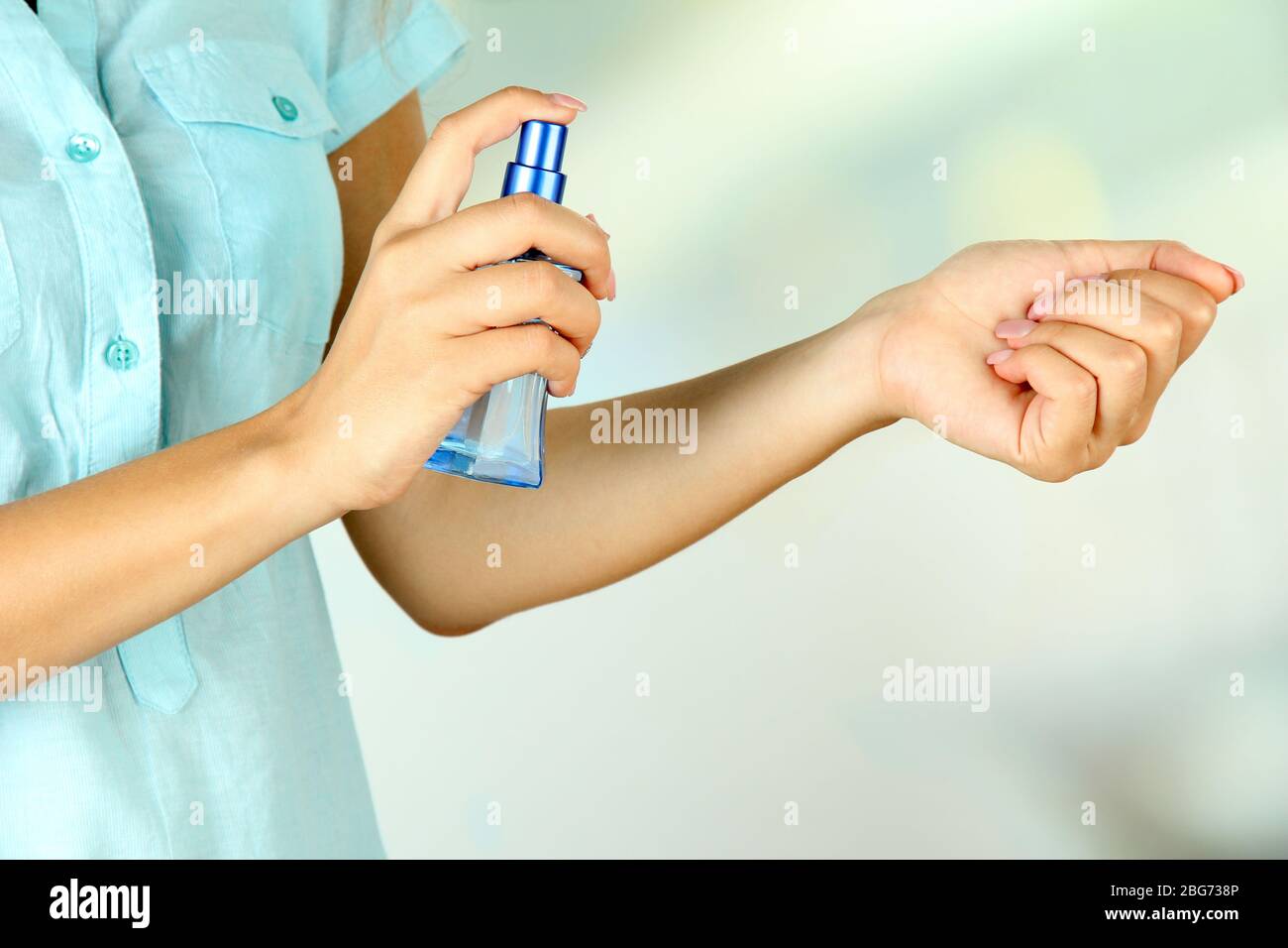 Woman testing perfume on natural background Stock Photo - Alamy