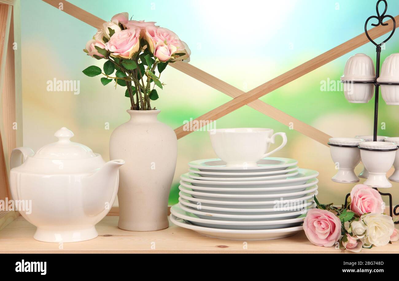 Lots beautiful dishes on wooden shelf on natural background Stock Photo ...