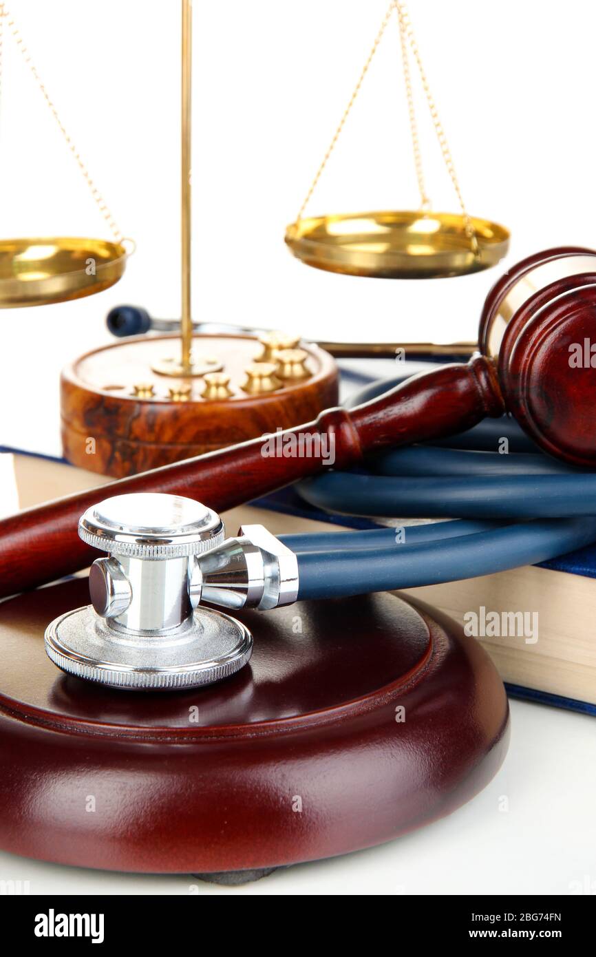 Medicine law concept. Gavel, scales and stethoscope on book close up ...
