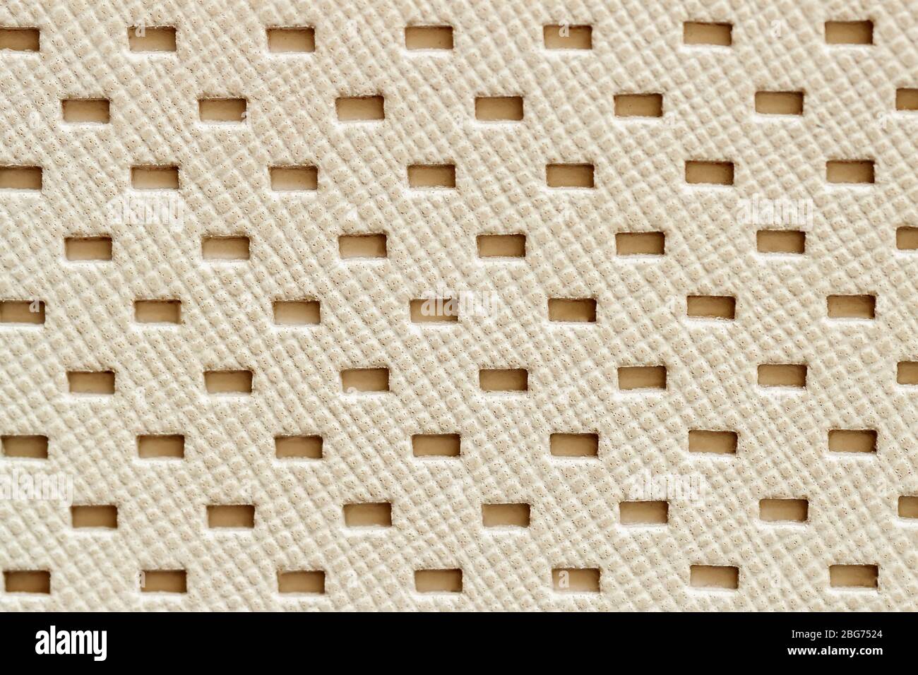 Texture of genuine geometric perforated genuine leather close-up, light ...