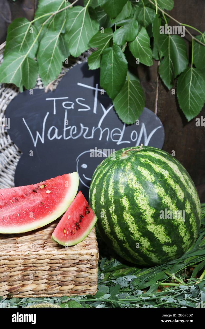 Ripe watermelon on grass near fence Stock Photo - Alamy