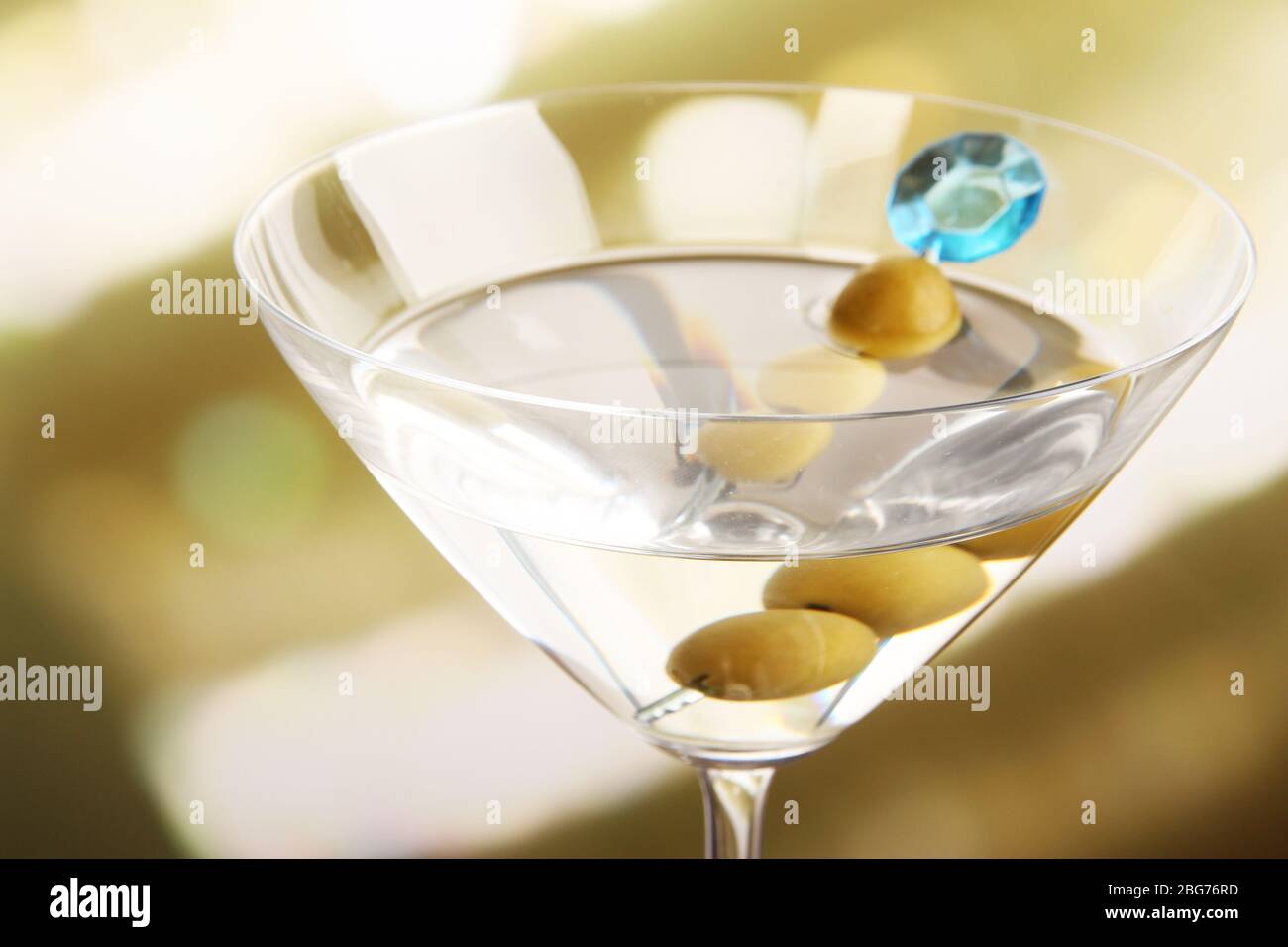 Martini with green olives on table in bar Stock Photo - Alamy