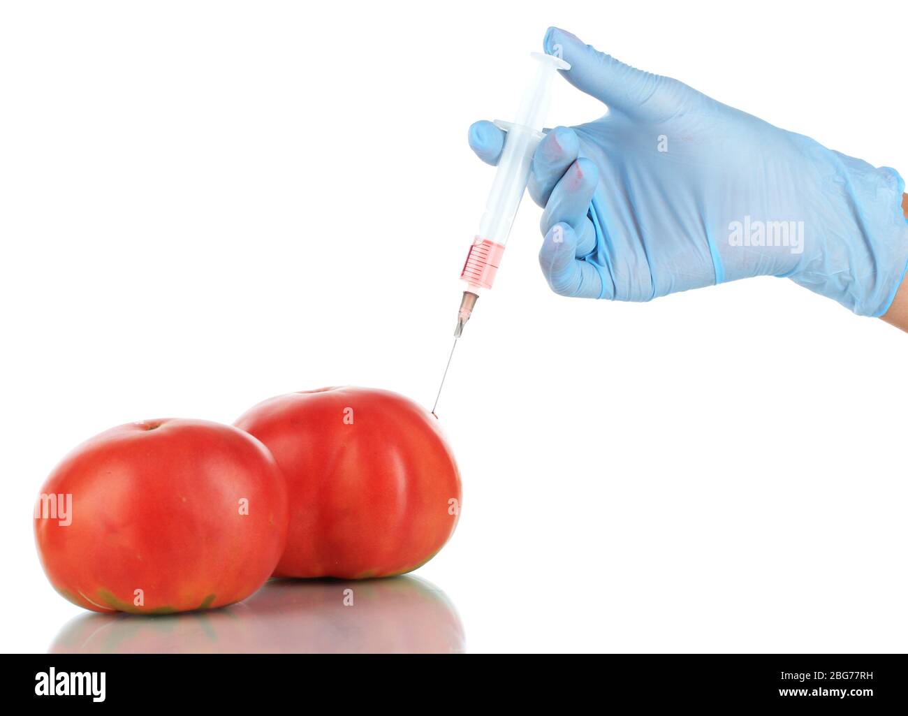 Injection into fresh red tomato isolated on white Stock Photo - Alamy