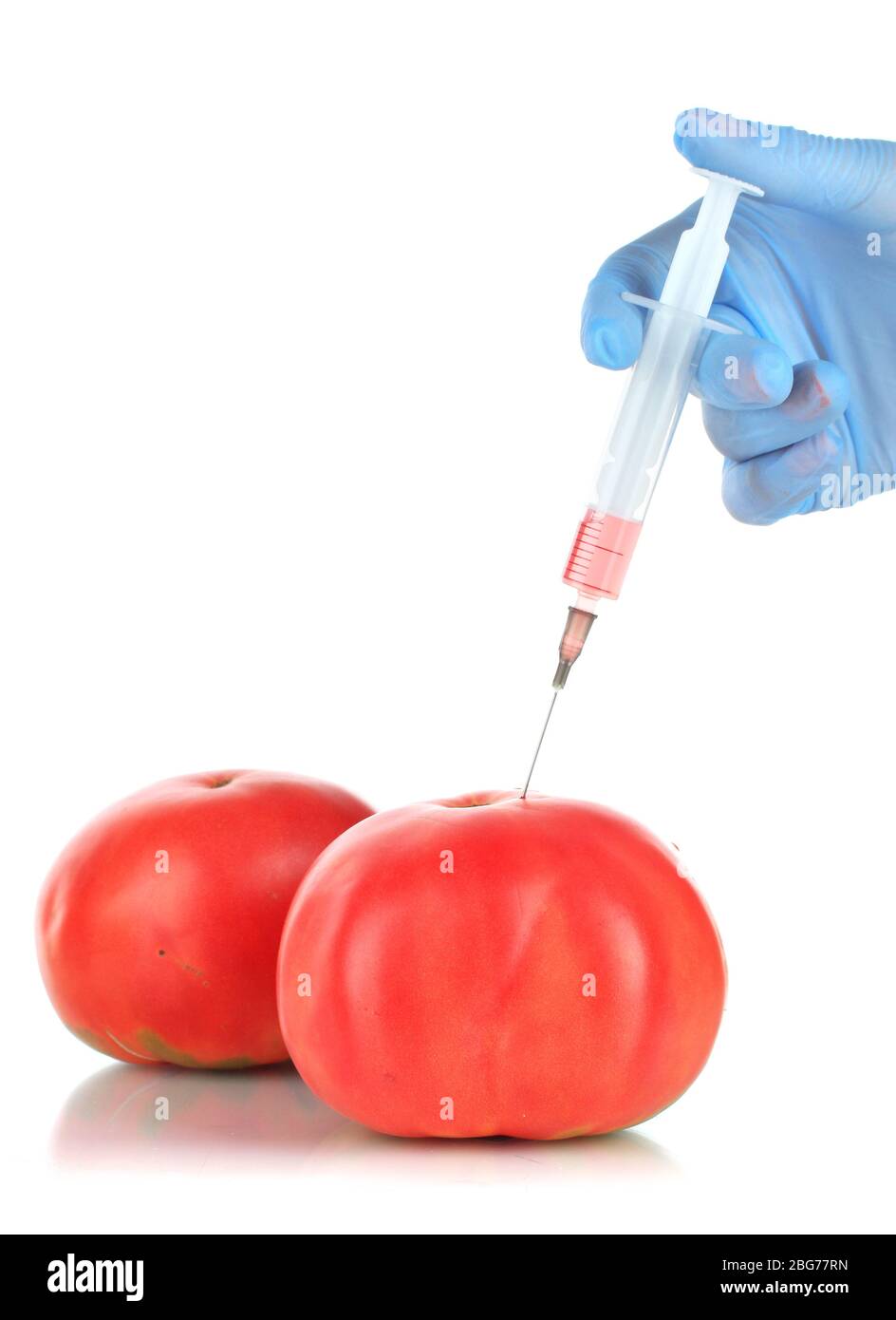Injection into fresh red tomato isolated on white Stock Photo - Alamy