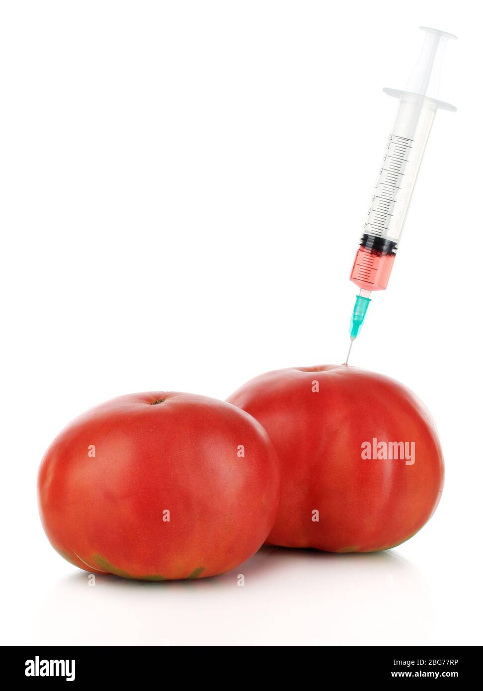 Injection into fresh red tomato isolated on white Stock Photo - Alamy