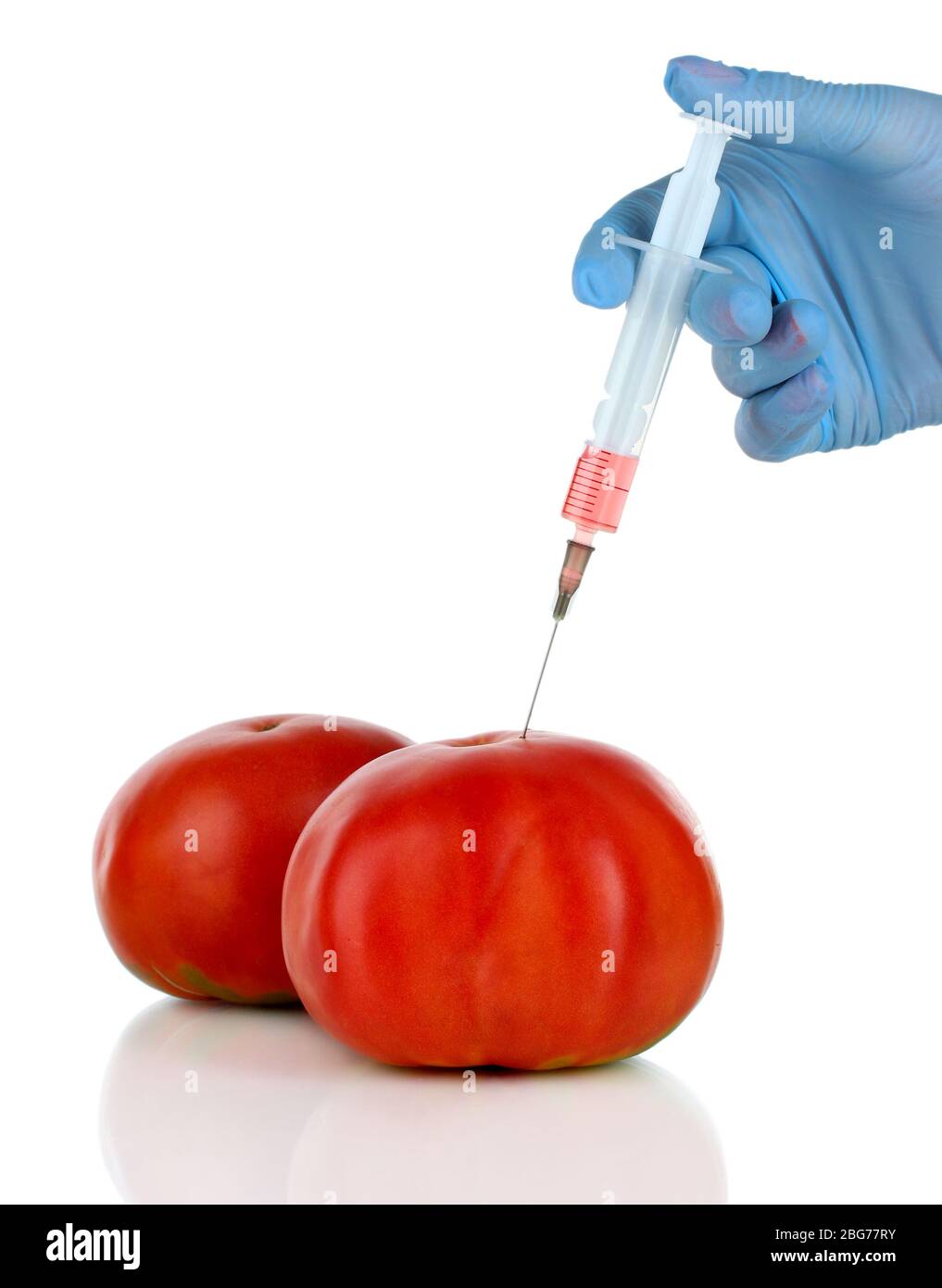 Injection into fresh red tomato isolated on white Stock Photo - Alamy