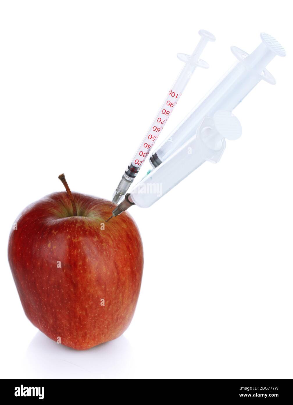 Injection into fresh red apple isolated on white Stock Photo - Alamy