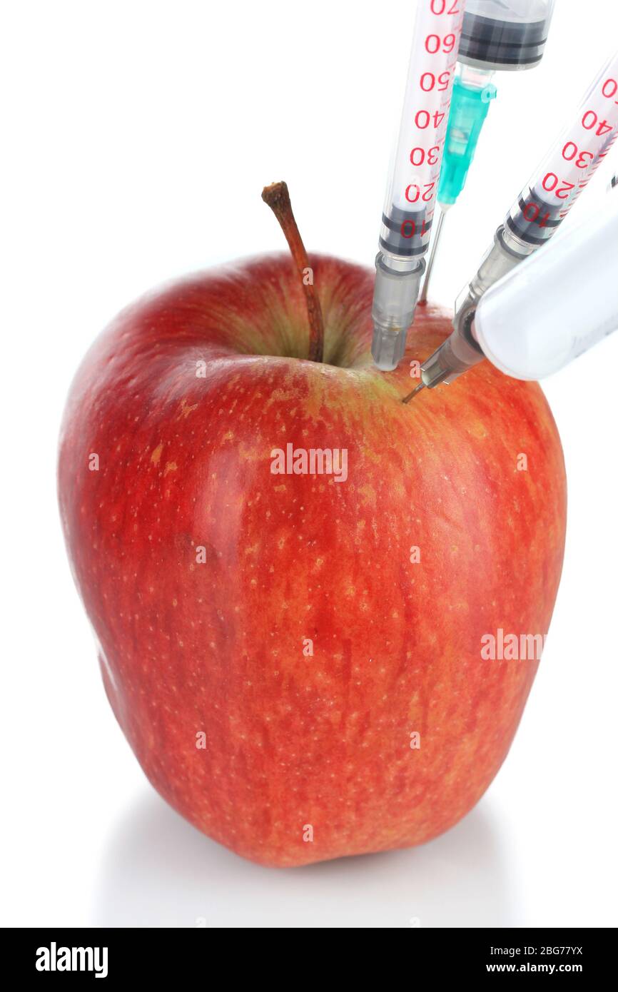 Injection into fresh red apple isolated on white Stock Photo - Alamy