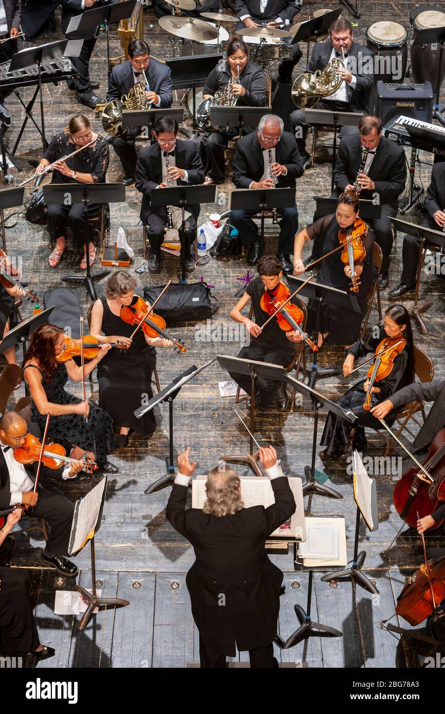 Overhead view of conductor leading orchestra (all model released) in ...