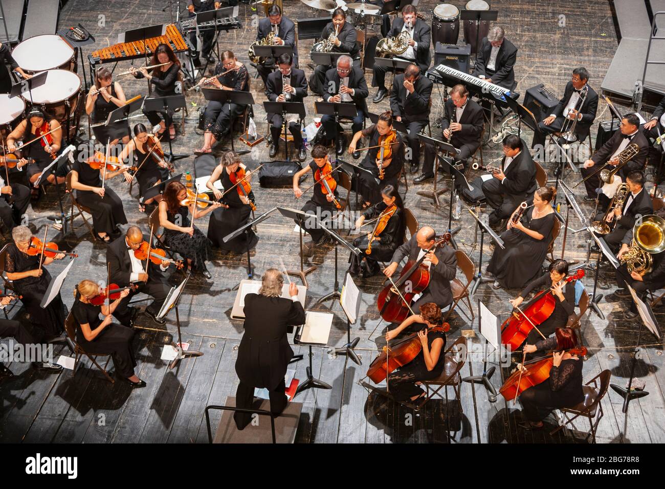 Overhead view of conductor leading orchestra (all model released) in ...
