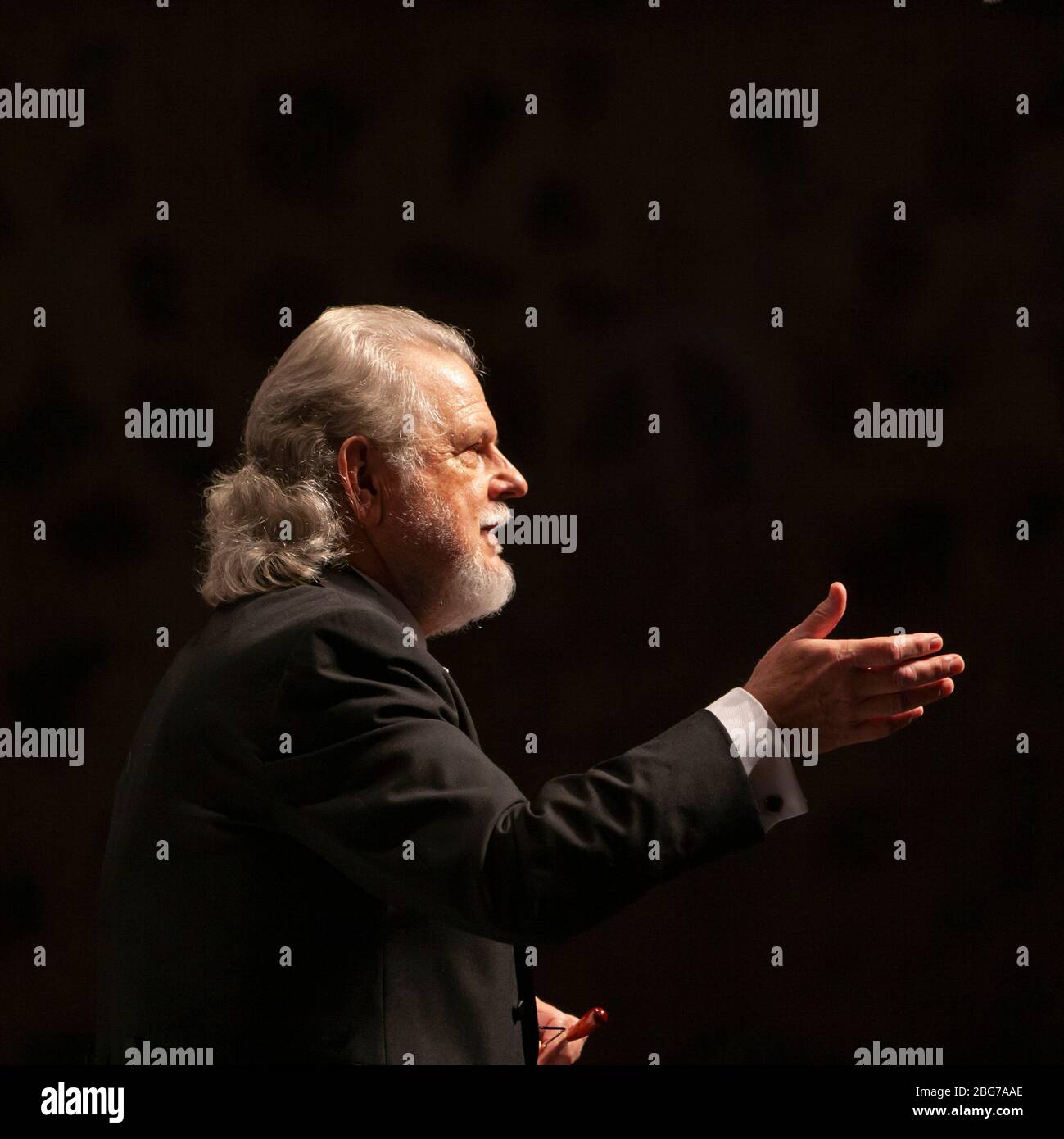 Conductor (model released) explains performance piece to audience Stock ...