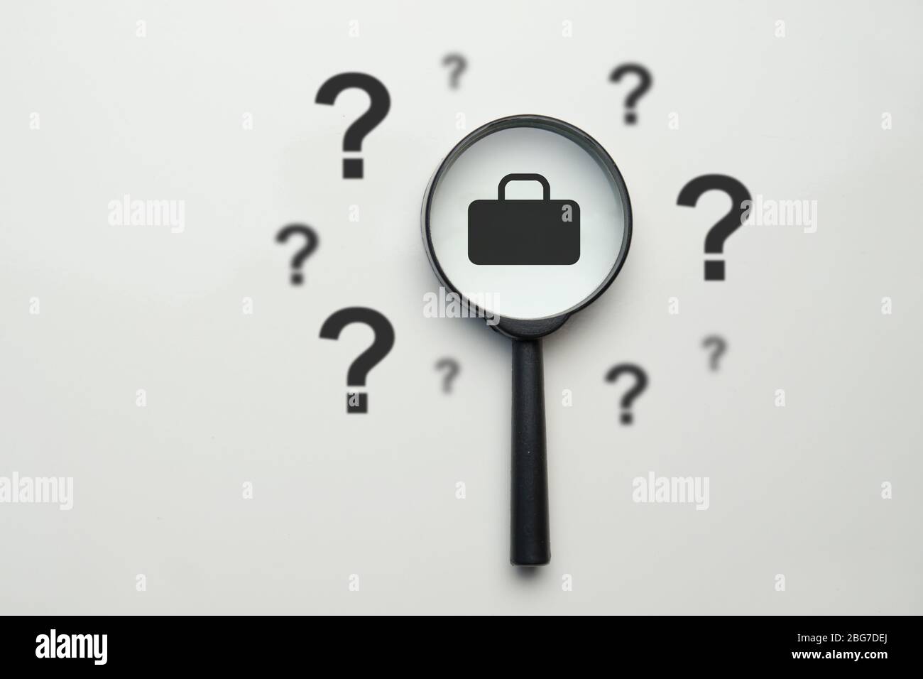 Job search concept - magnifying glass with case and question marks ...
