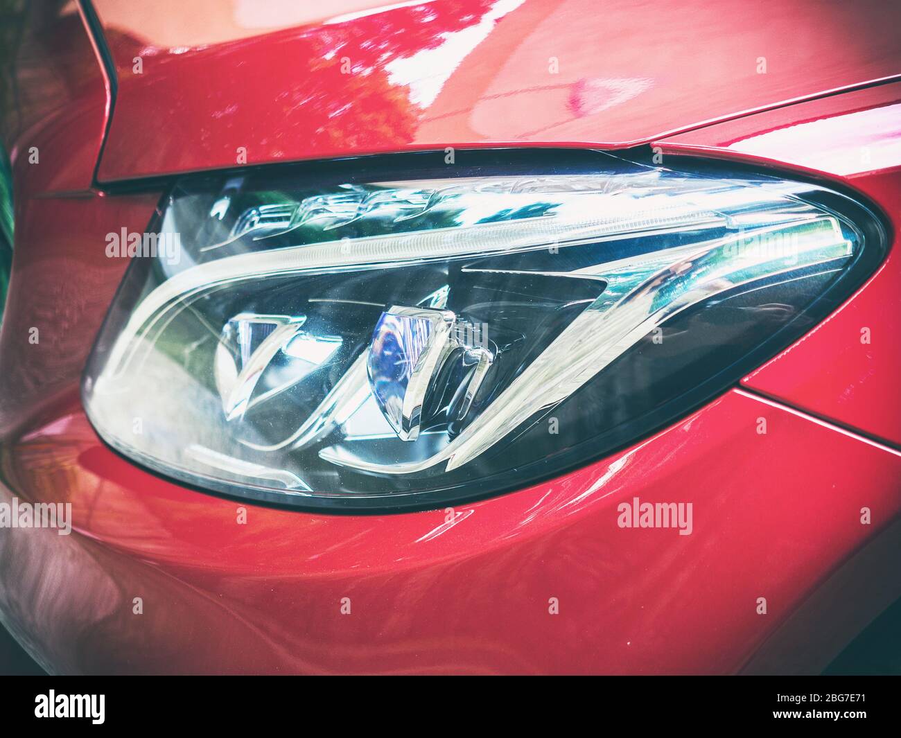 Beautiful front headlight red car on street Stock Photo - Alamy