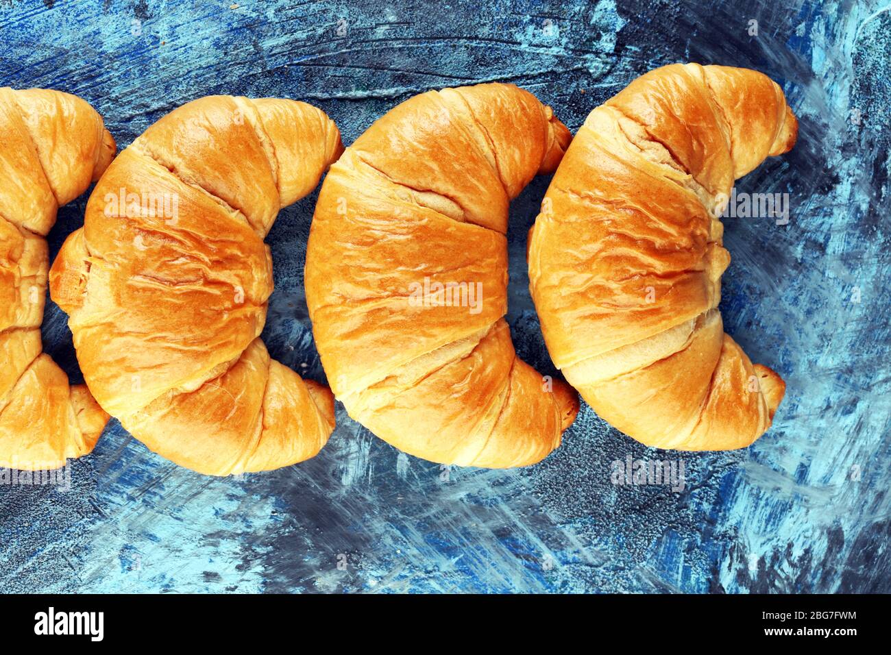 freshly baked croissants on rustic board, bakery breakfast concept ...