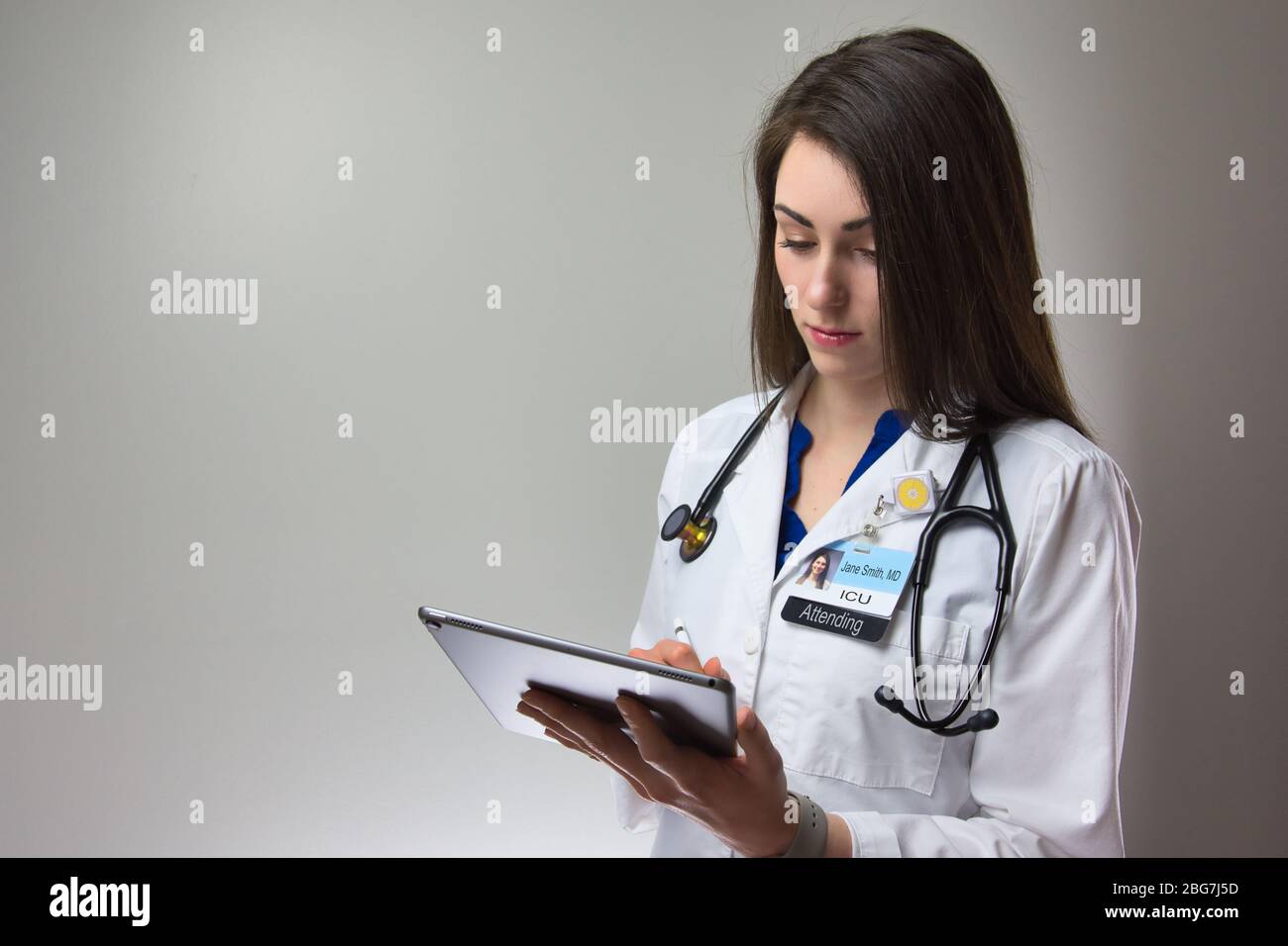 Lady healthcare worker using technology to care for patient. Woman in ...
