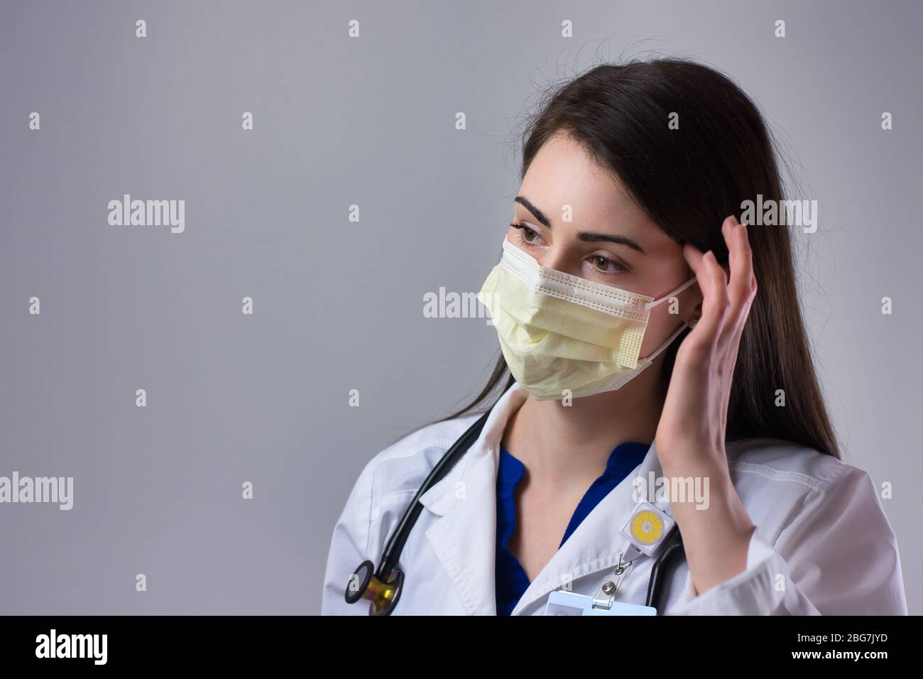 Female healthcare worker adjusting mask. Working with Coronavirus ...