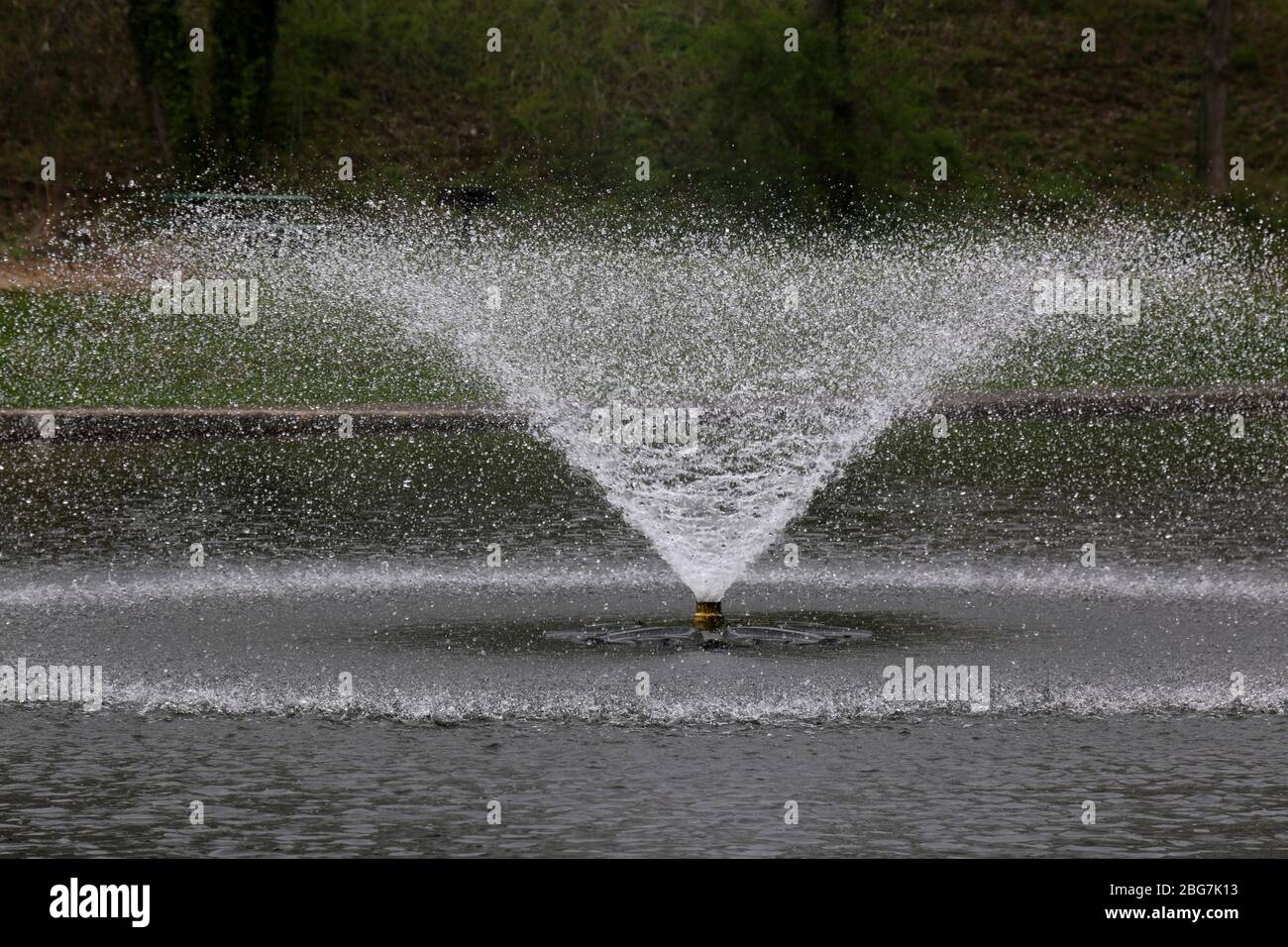 The fountain is spraying the water in the lake Stock Photo - Alamy