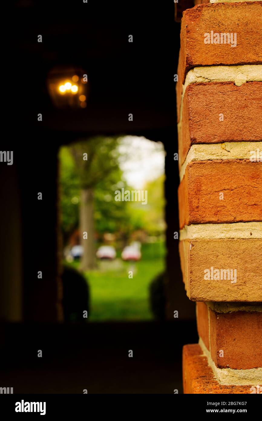 Brick Corner of Building Looking into a Dark Hallway Stock Photo - Alamy
