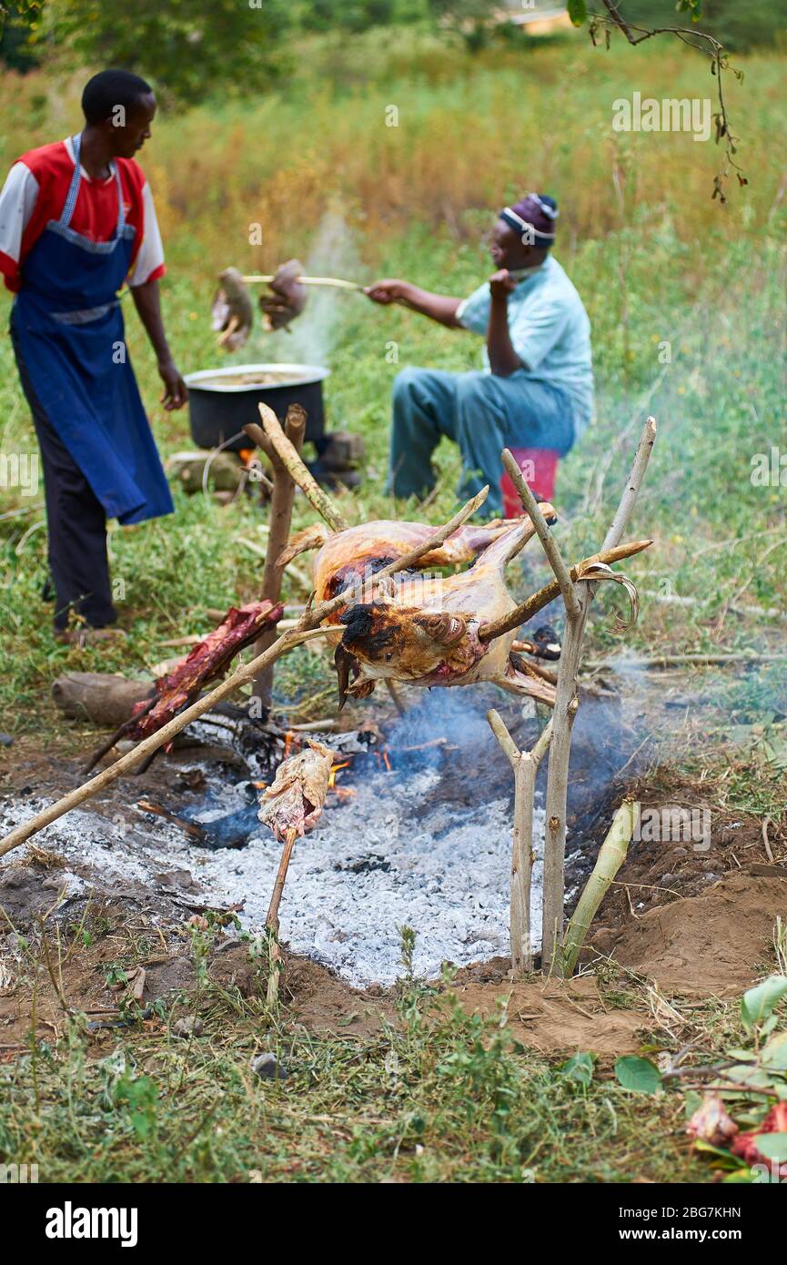 Maasai preparing a goat for a traditional barbecue Stock Photo - Alamy