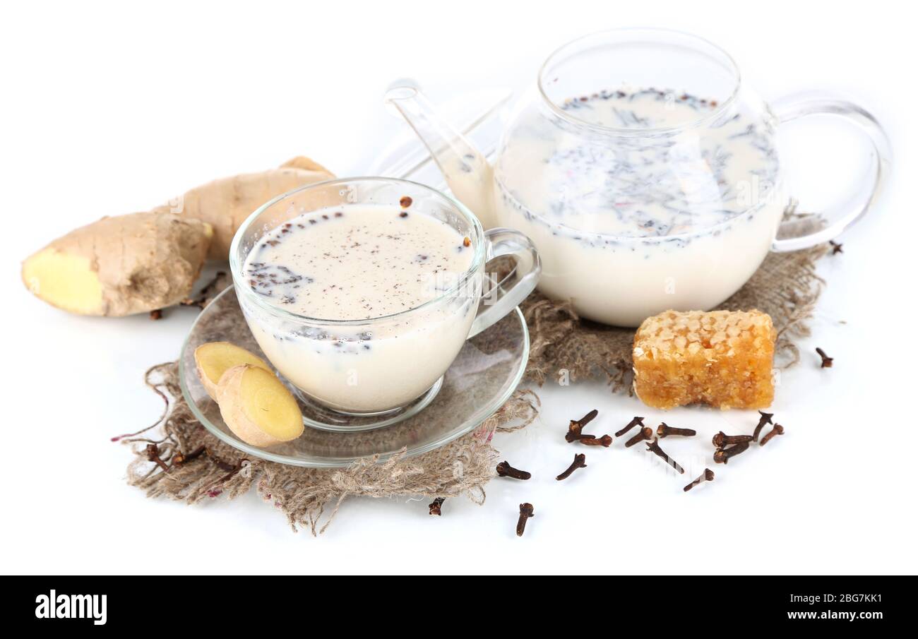Teapot and cup of tea with milk and spices on sackcloth isolated on ...