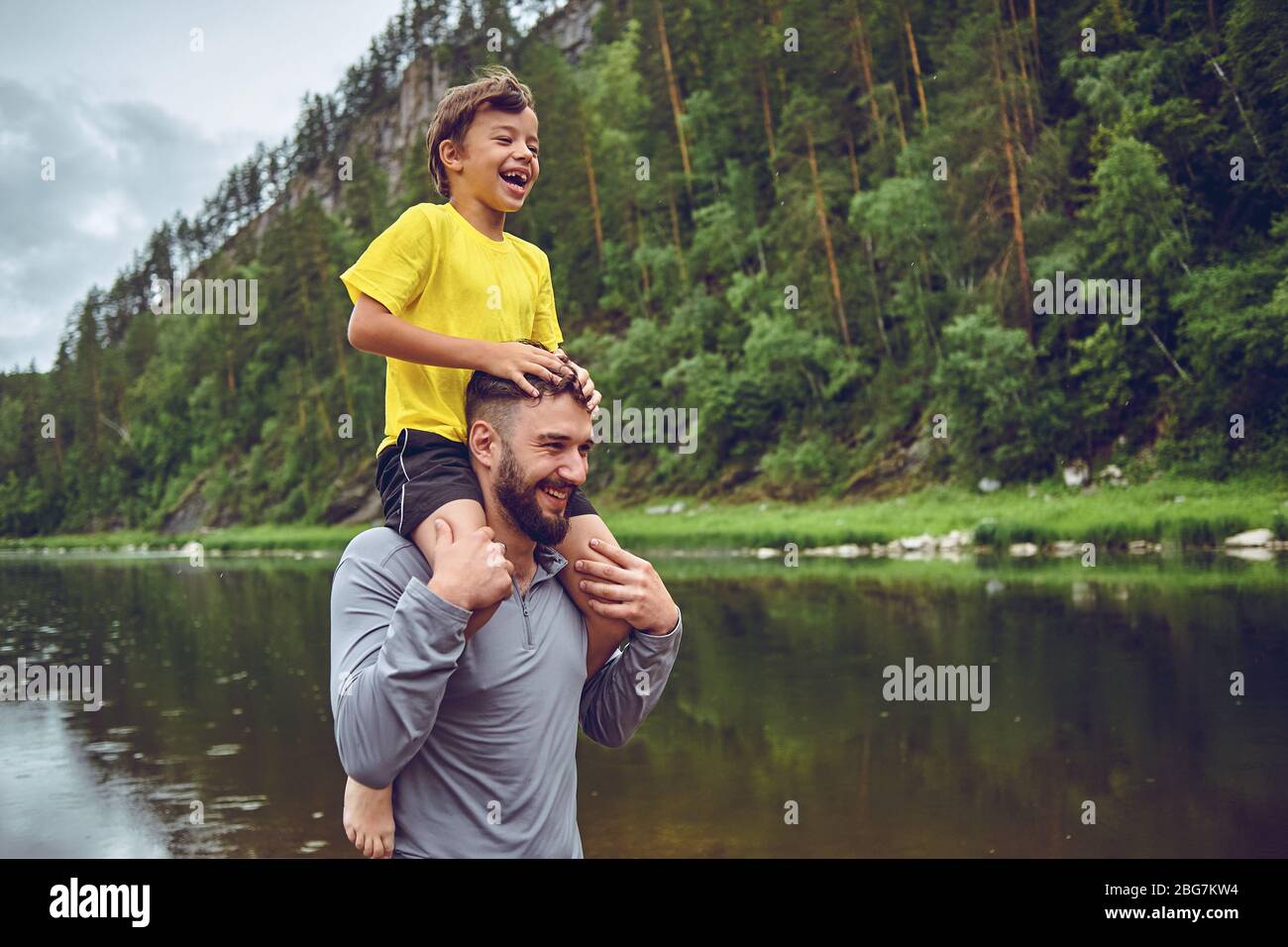 Having fun. Father example of noble human. Child riding on dads ...