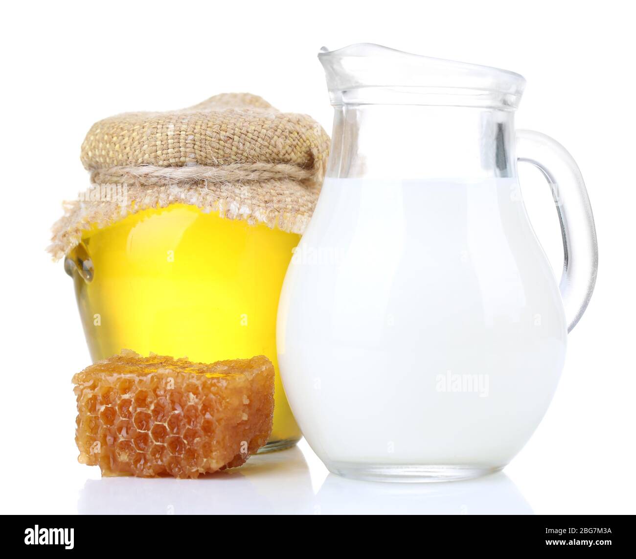 Honey and milk isolated on white Stock Photo - Alamy