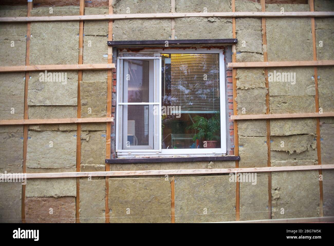 warming the walls of a stone house with a stone wool heater. Ecological ...
