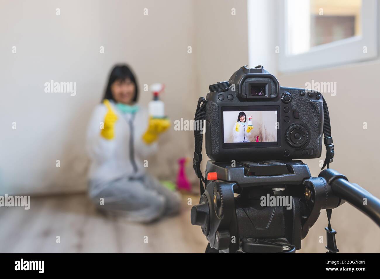 Video camera filming how woman cleaning mold from wall using spray ...