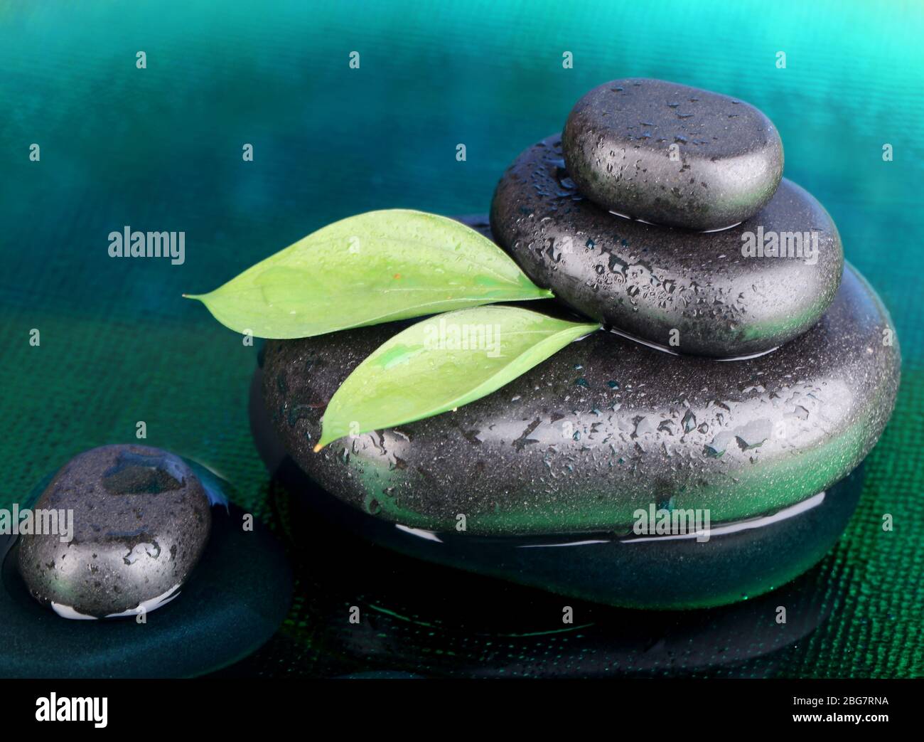 Spa stones in water close-up Stock Photo - Alamy