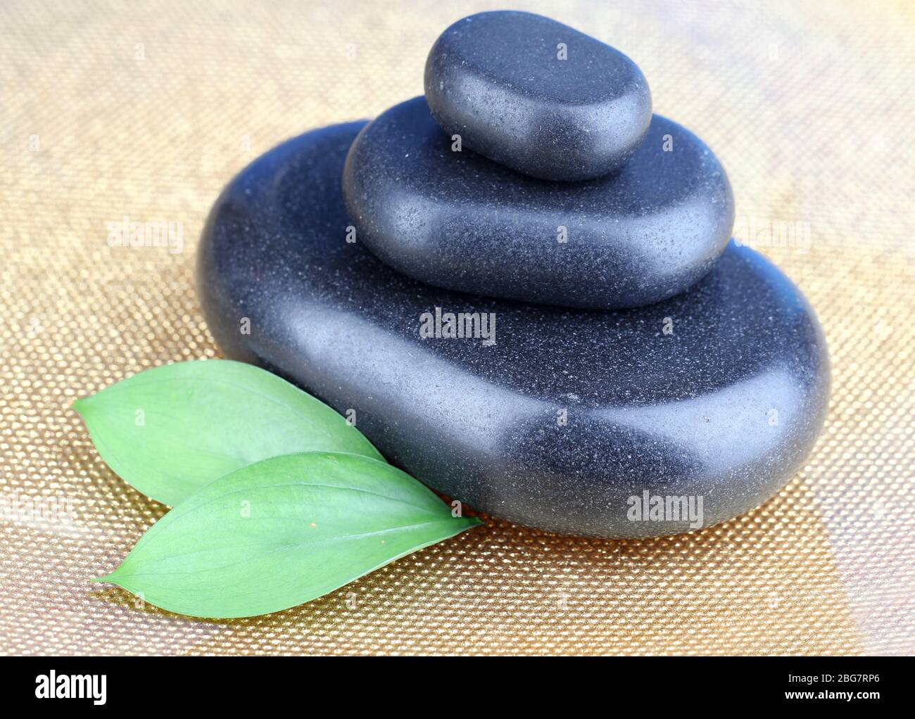 Spa stones on gold background close-up Stock Photo - Alamy