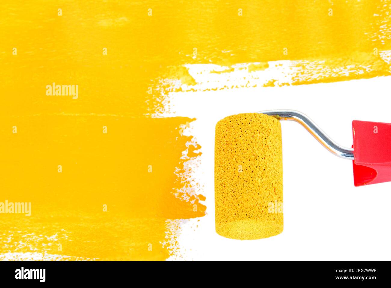 Roller brush with yellow paint Stock Photo - Alamy