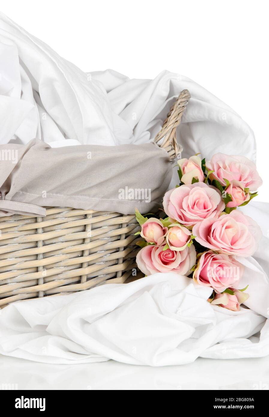 Rumpled bedding sheets in wicker basket isolated on white Stock Photo ...