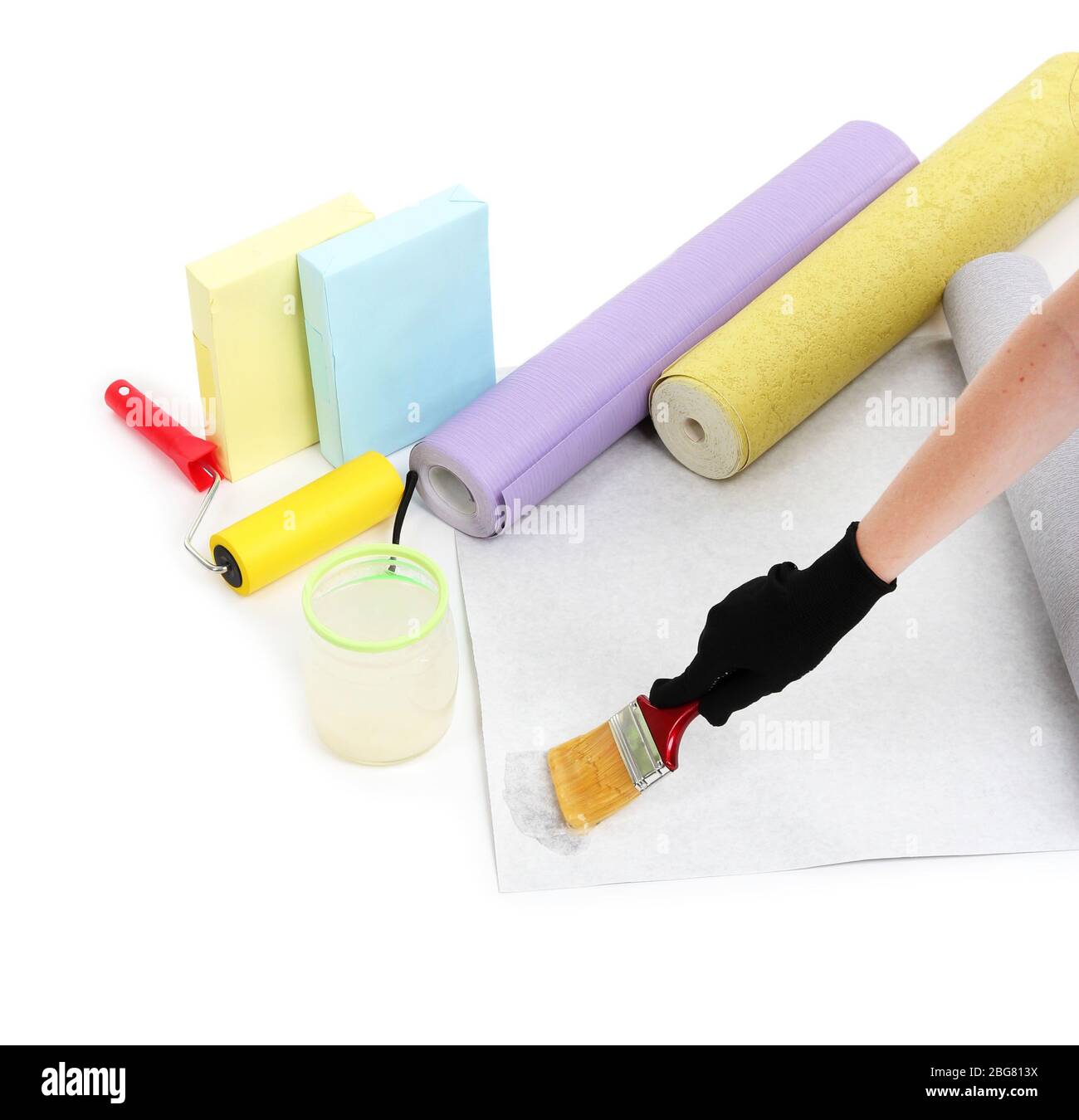 Hand smearing wallpaper by glue, isolated on white Stock Photo - Alamy