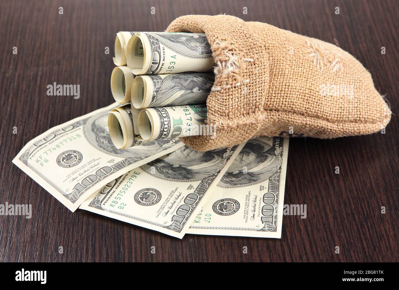Money in bag on dark background Stock Photo - Alamy