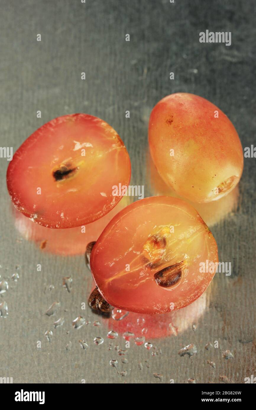 Ripe sliced grape and seeds, close up Stock Photo - Alamy