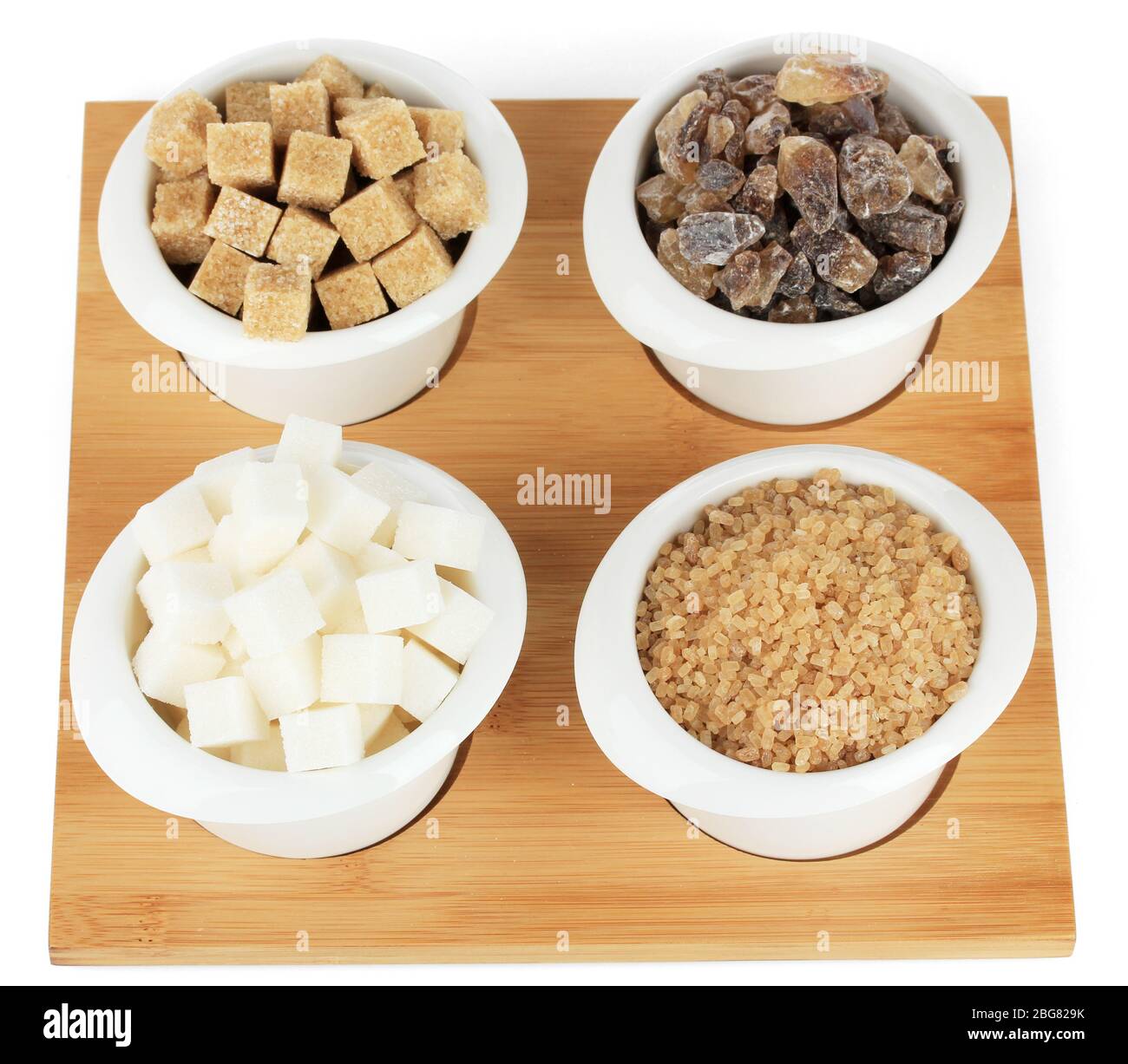 Different types of sugar in bowls isolated on white Stock Photo - Alamy