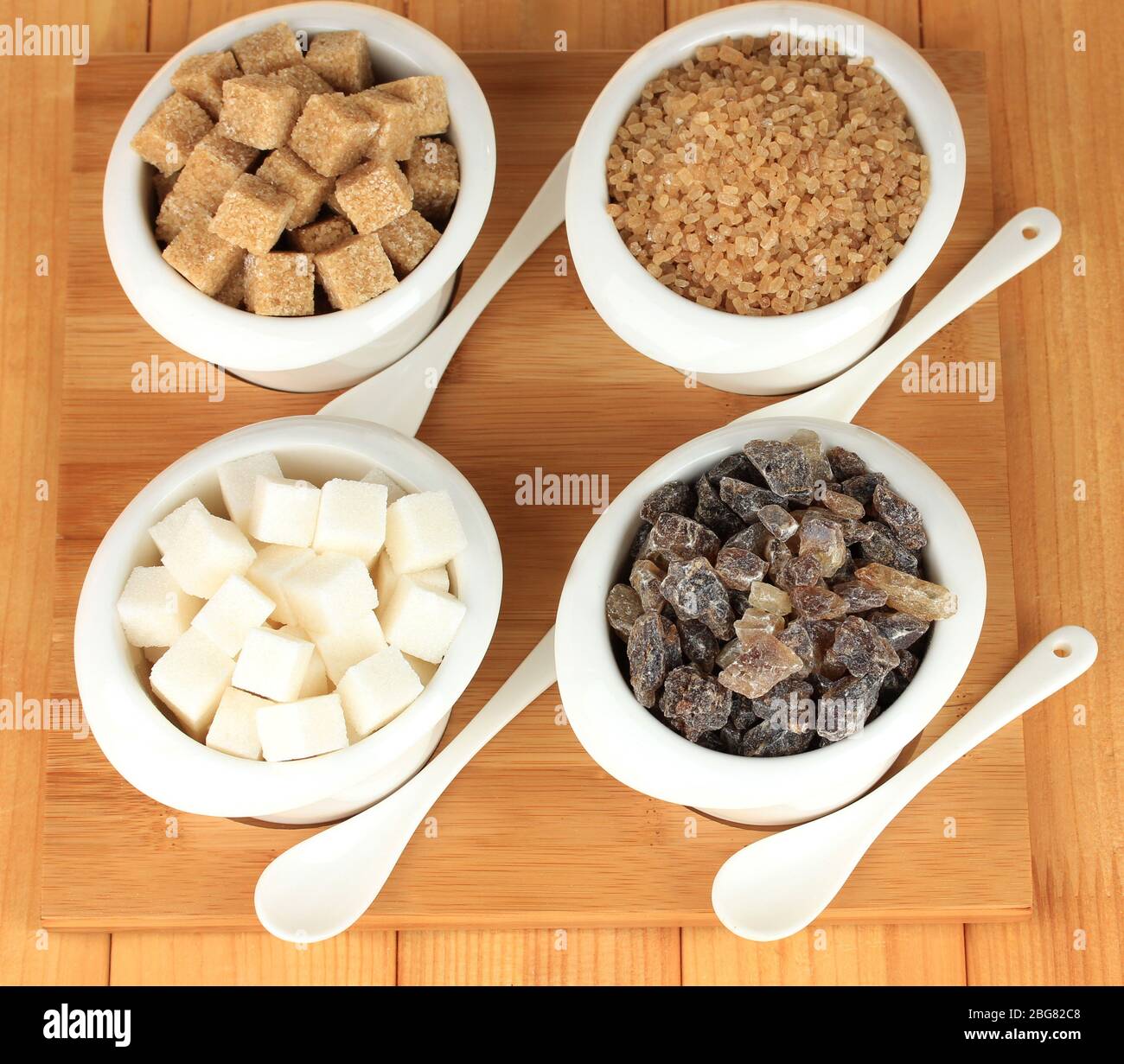Different types of sugar in bowls on table close-up Stock Photo - Alamy