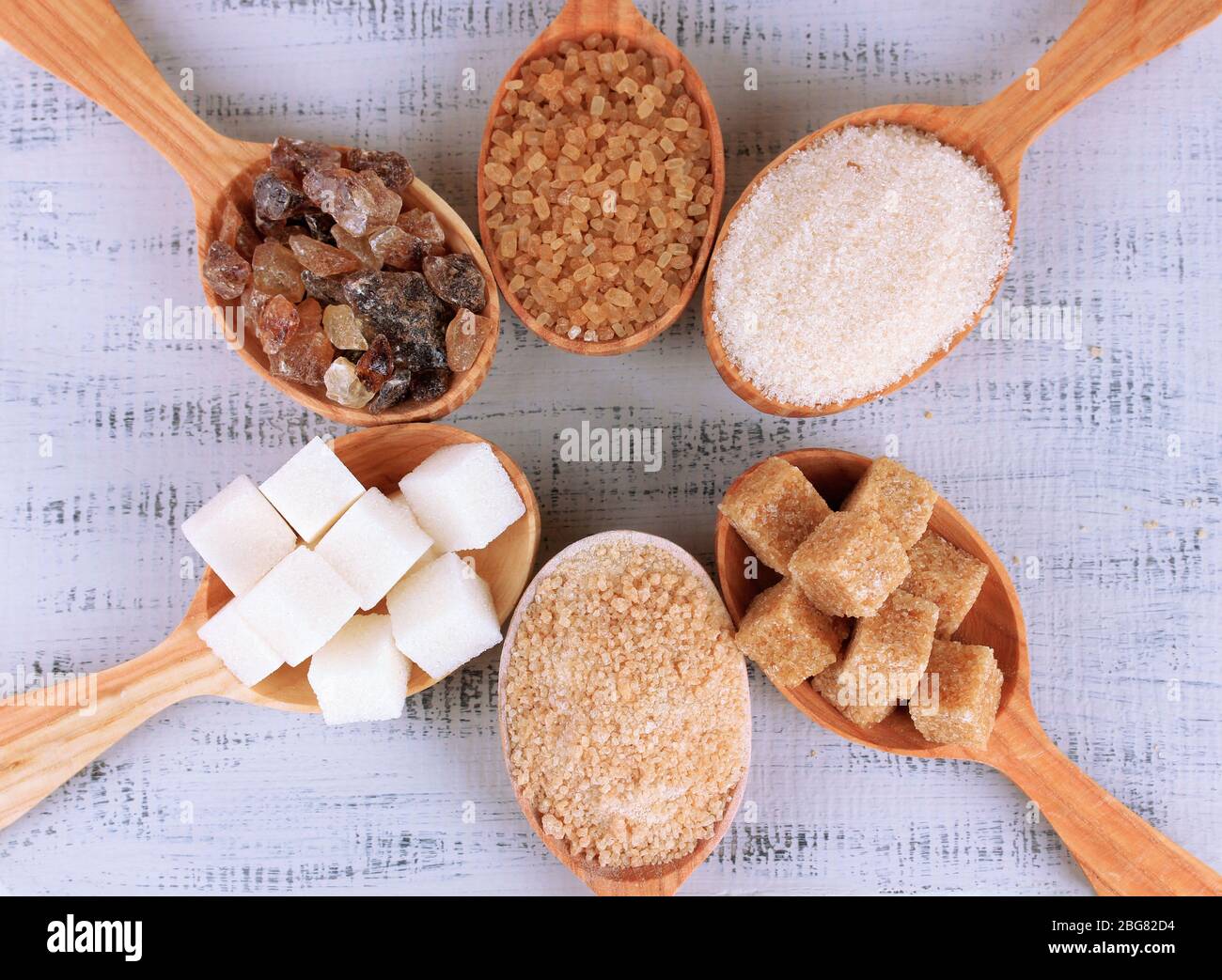 Different types of sugar in spoons on table close-up Stock Photo - Alamy