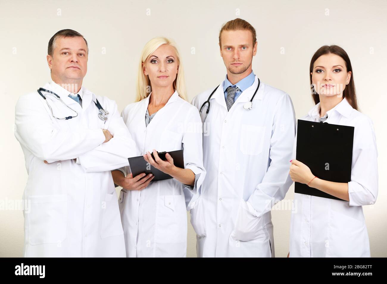 Medical workers on grey background Stock Photo - Alamy