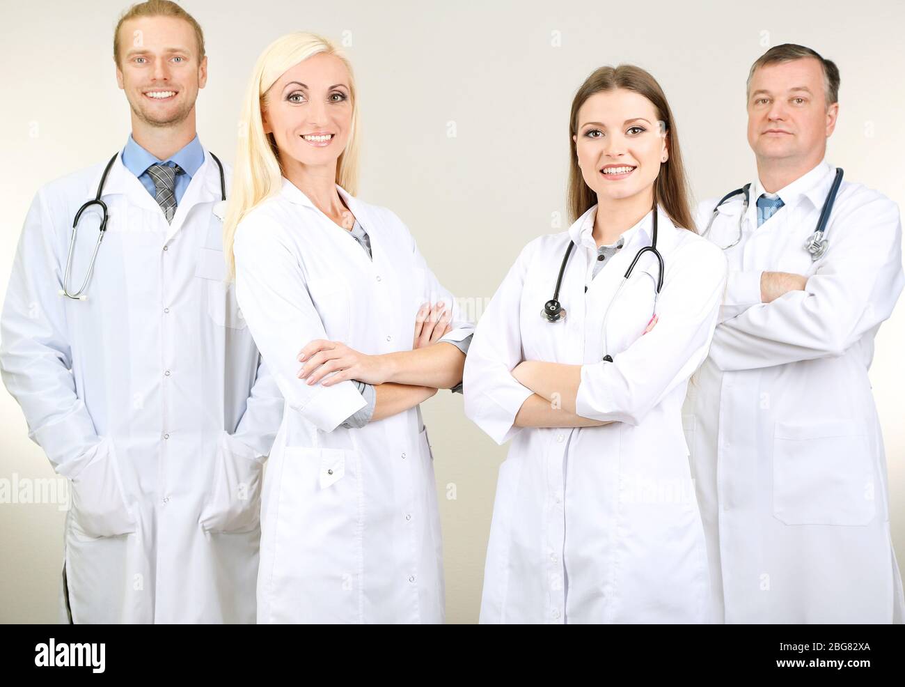 Medical workers on grey background Stock Photo - Alamy